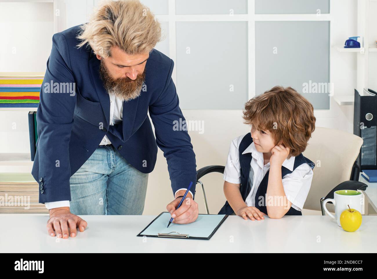 Boss and employee. Little boss and employee in the office. Old and yong ...