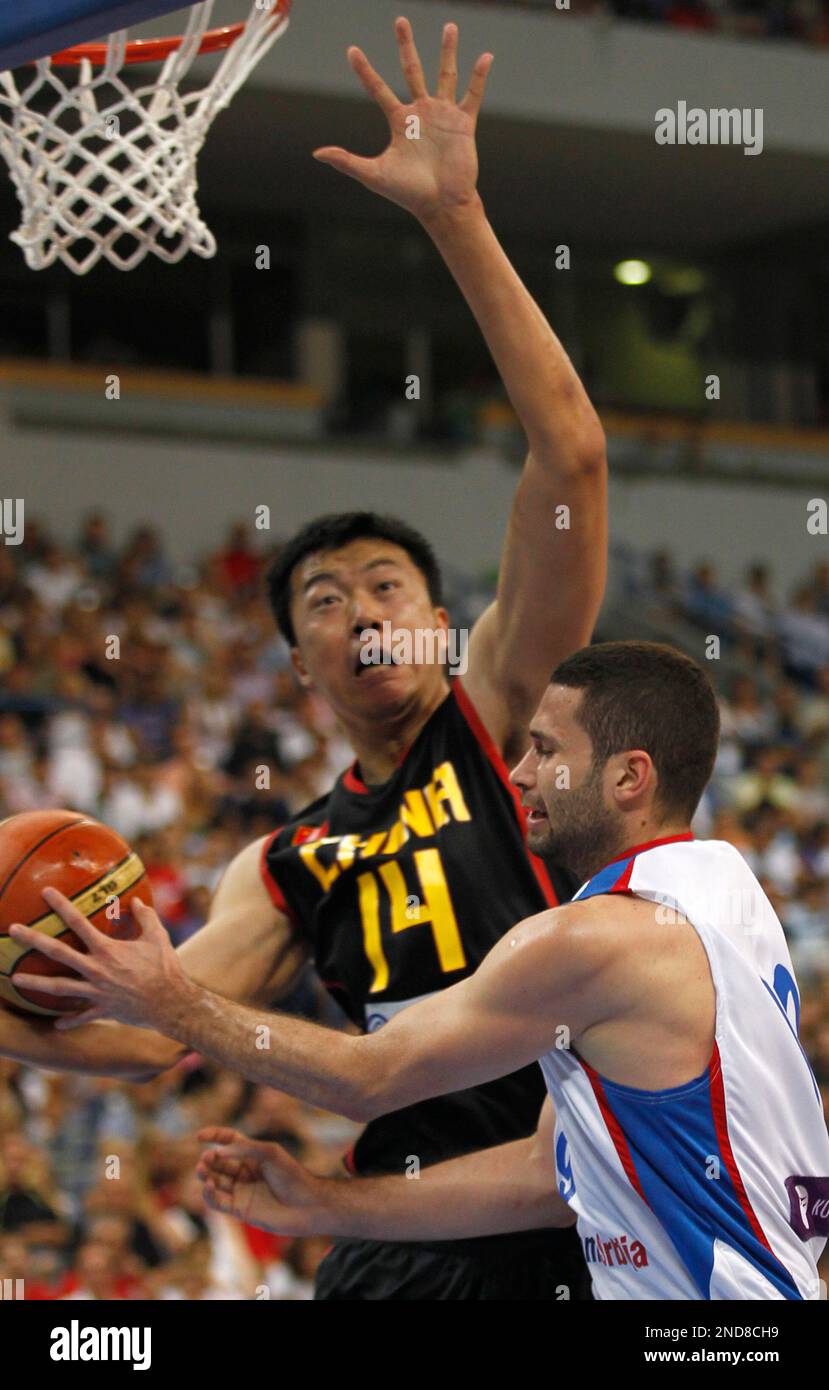 Serbia's Aleksandar Rasic, right, drives to the basket as he is guarded ...