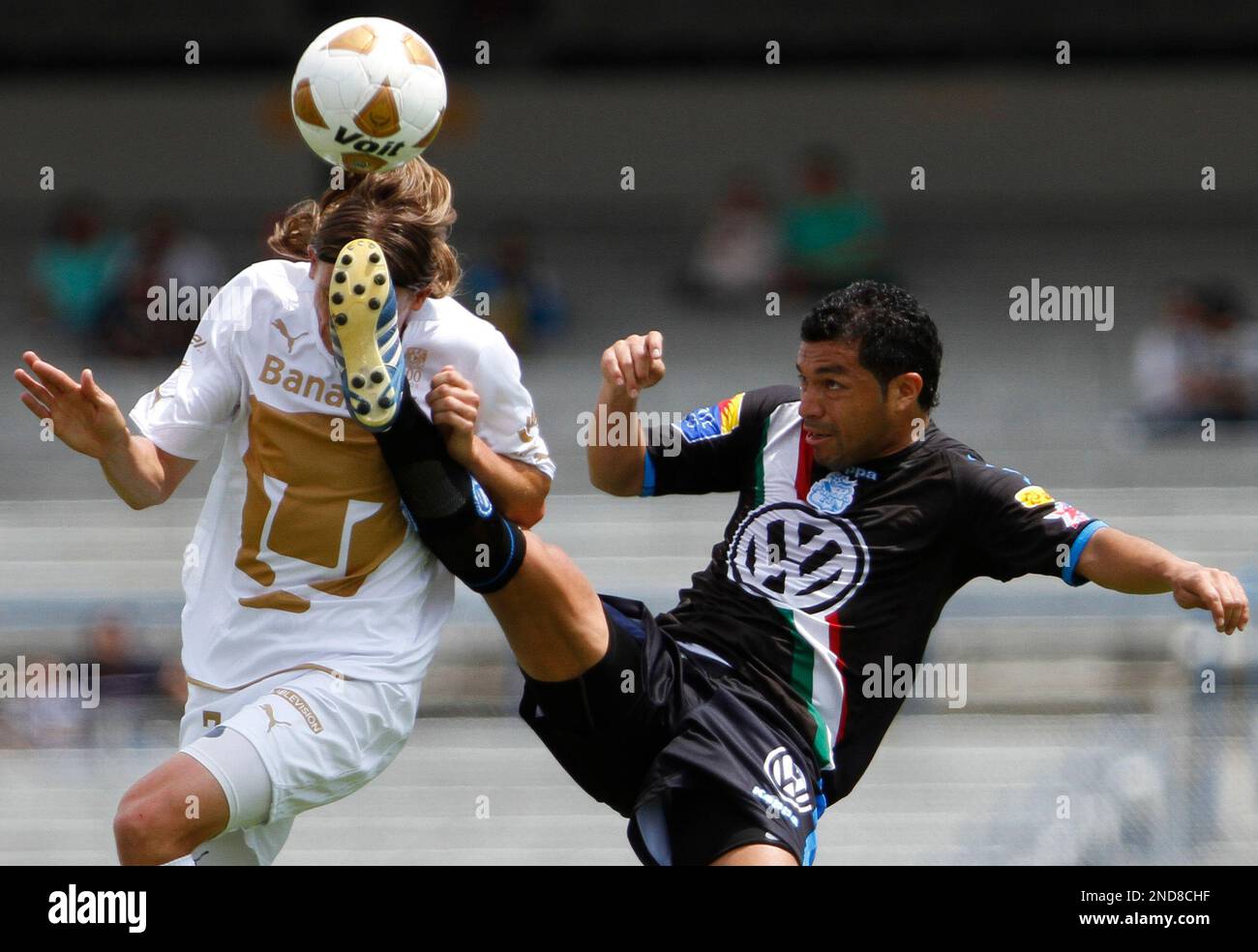 Pumas' Leandro Augusto, left, is fouled by Puebla's Felipe De Jesus ...