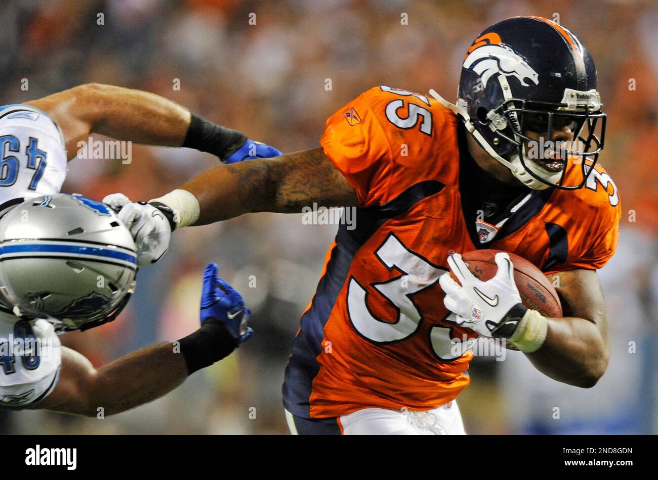 Denver Broncos running back Lance Ball runs past Detroit Lions ...