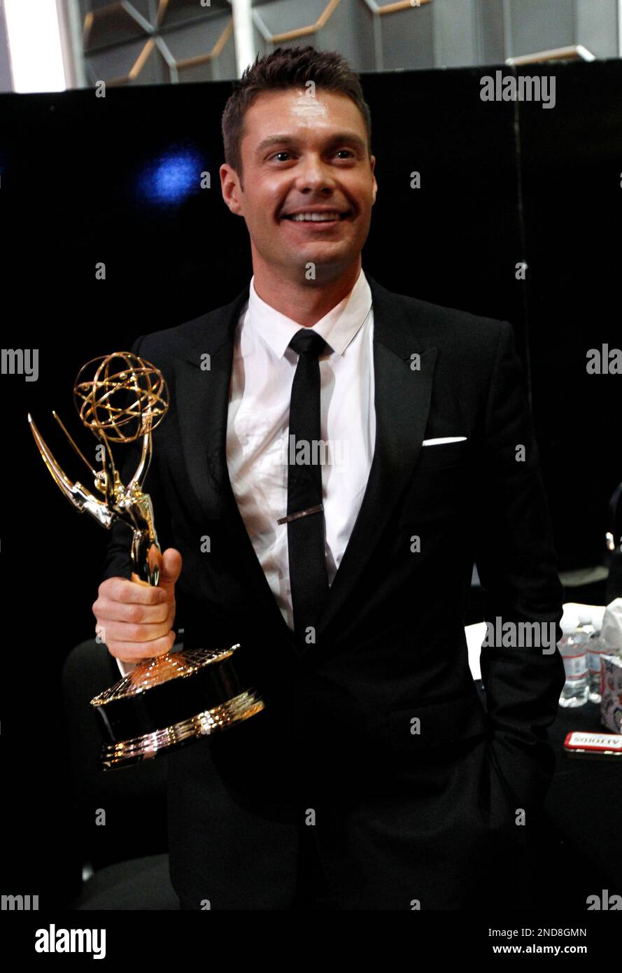 Ryan Seacrest poses backstage with his award for outstanding reality ...