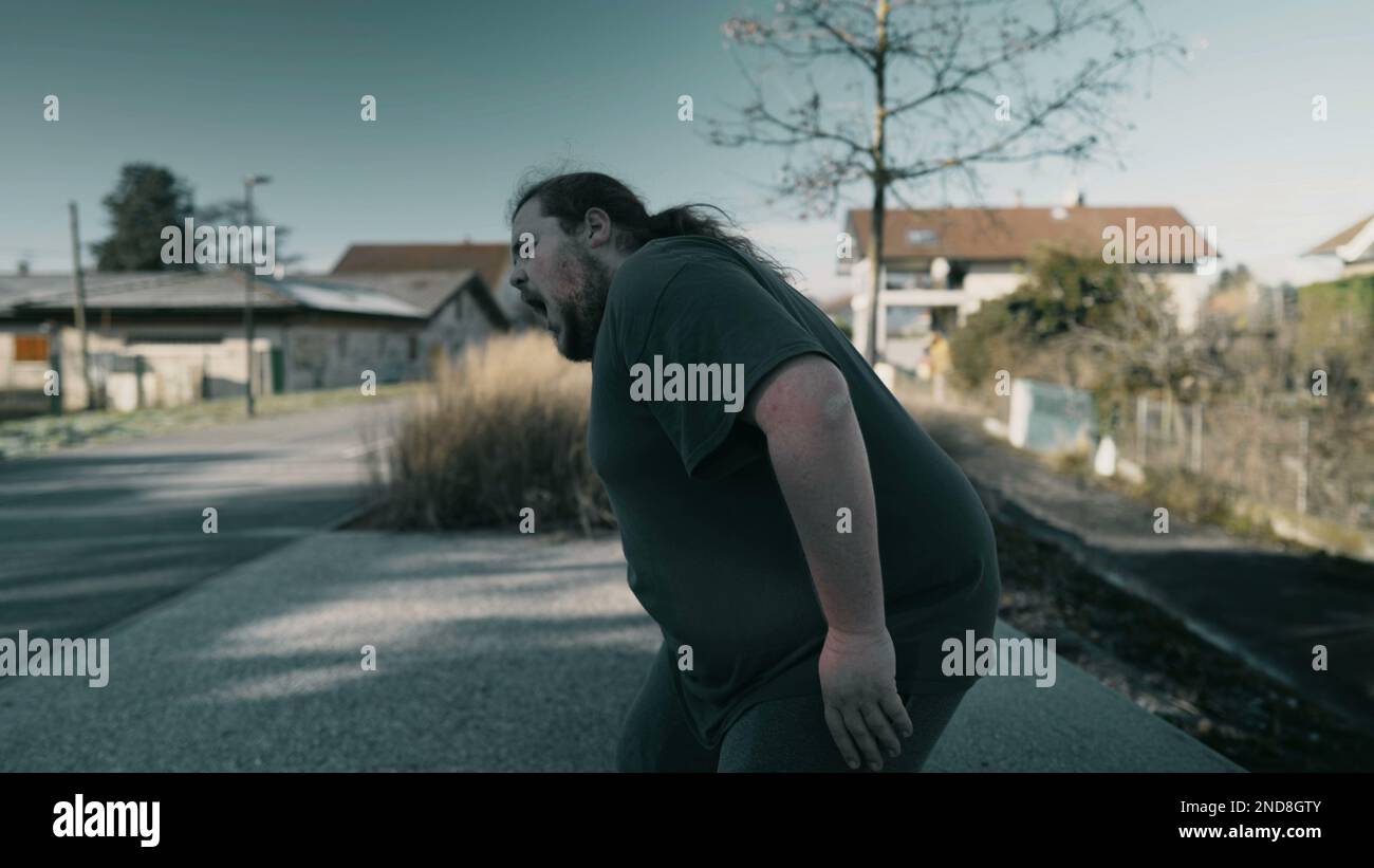 Person reacting to physical chronic back pain. One chubby fat man ...