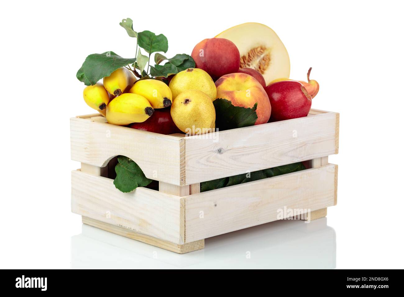 Fresh fruits in a wooden box isolated on a white background. Apples ...