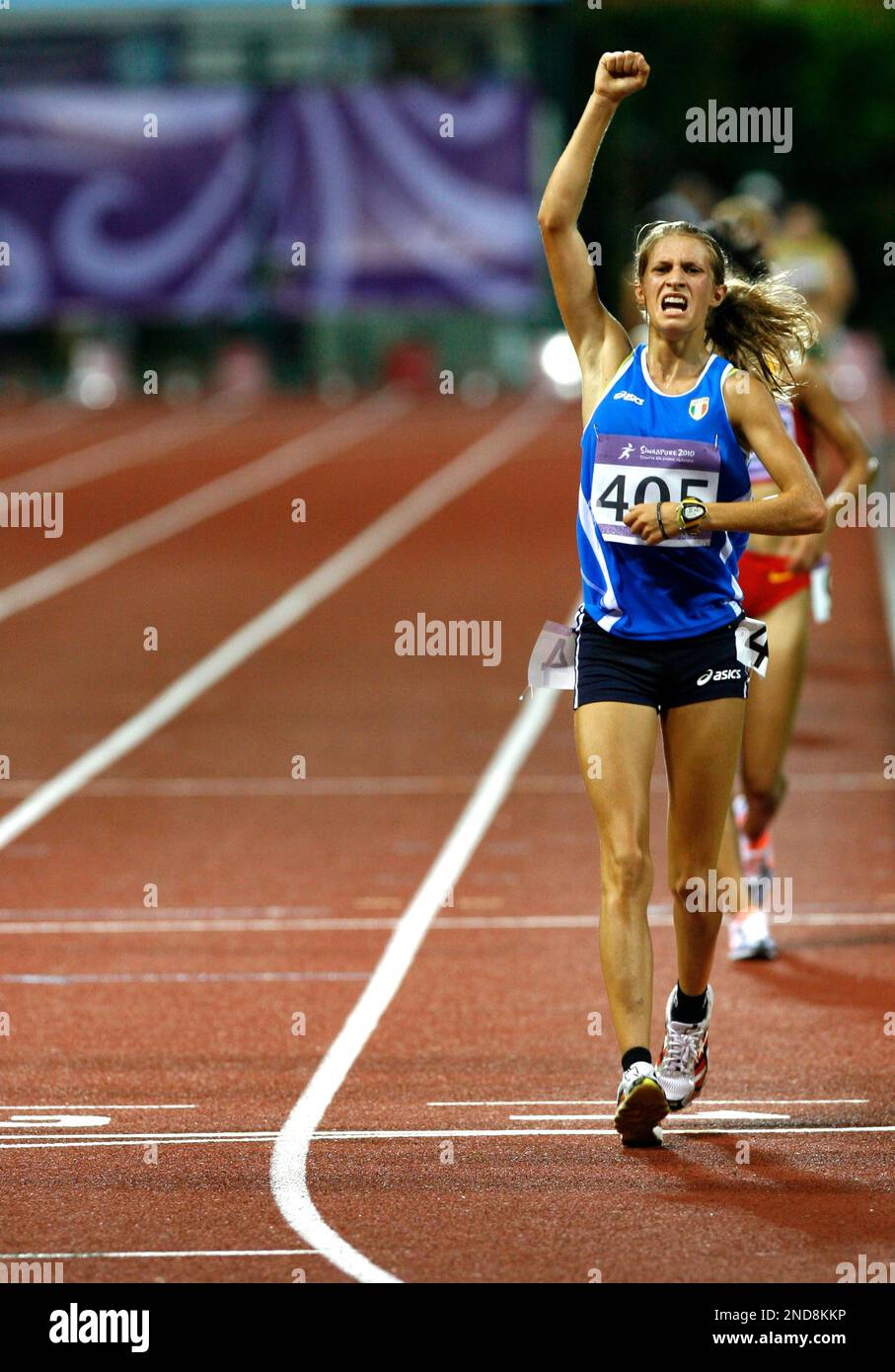 Anna Clemente of Italy celebrates after crossing the finish line to win ...