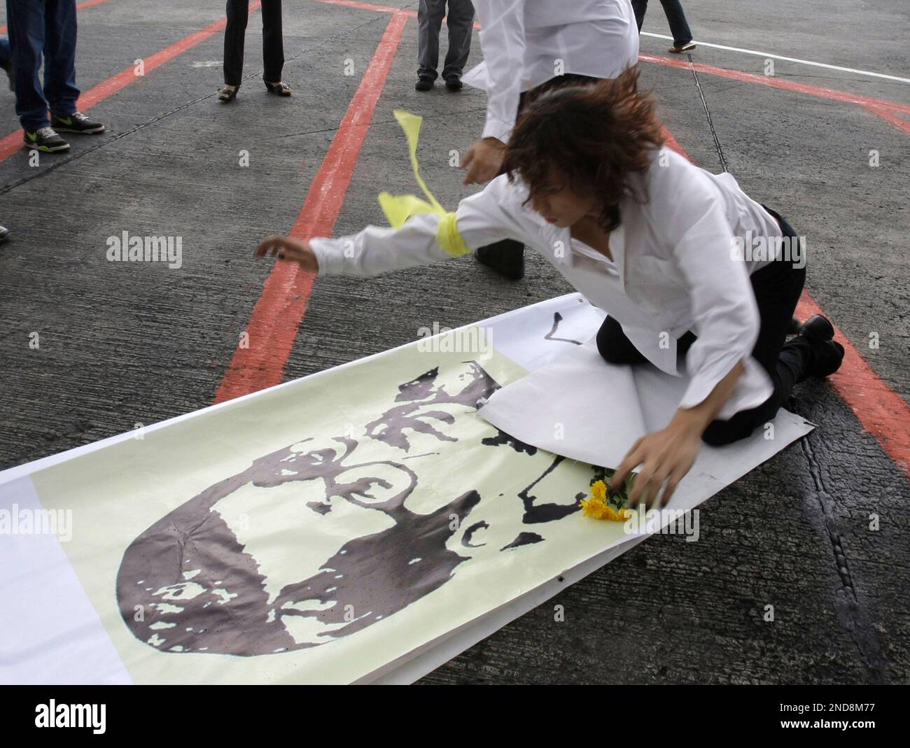 A man falls to the ground as he portrays the assassination of former ...