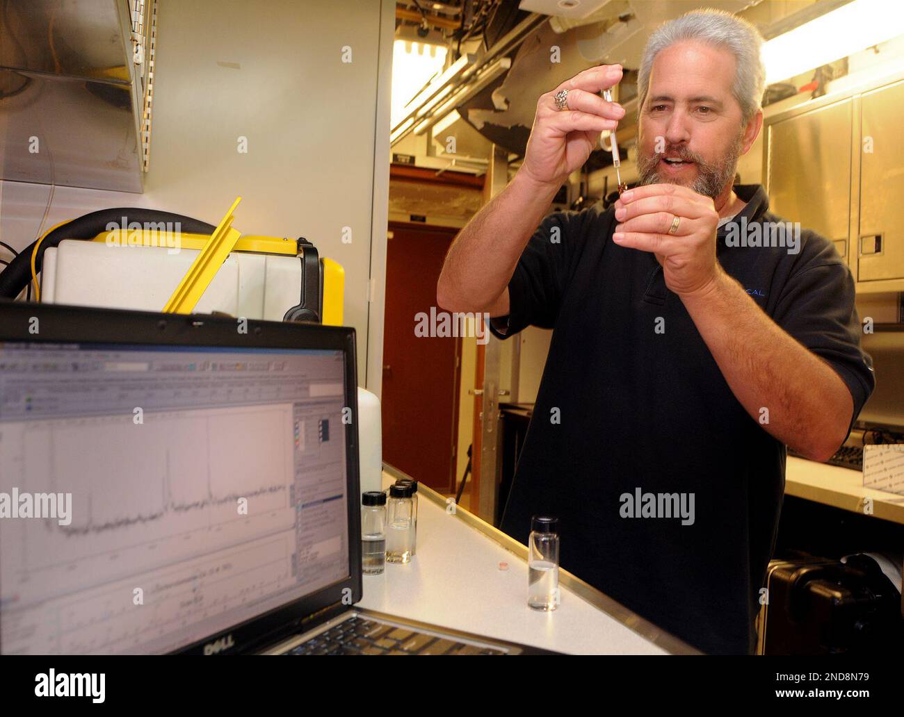 Dan Schenk of KD Analytical gets a sample water from the Gulf of Mexico ...