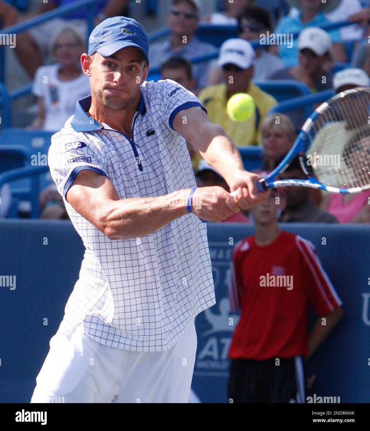 Andy Roddick, from the United States, returns a volley to Novak ...
