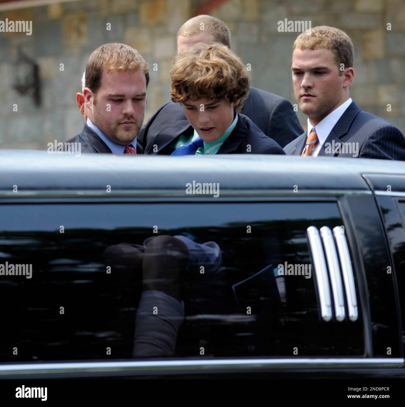 William "Willy" Phillips Jr., is helped into a limousine following the ...