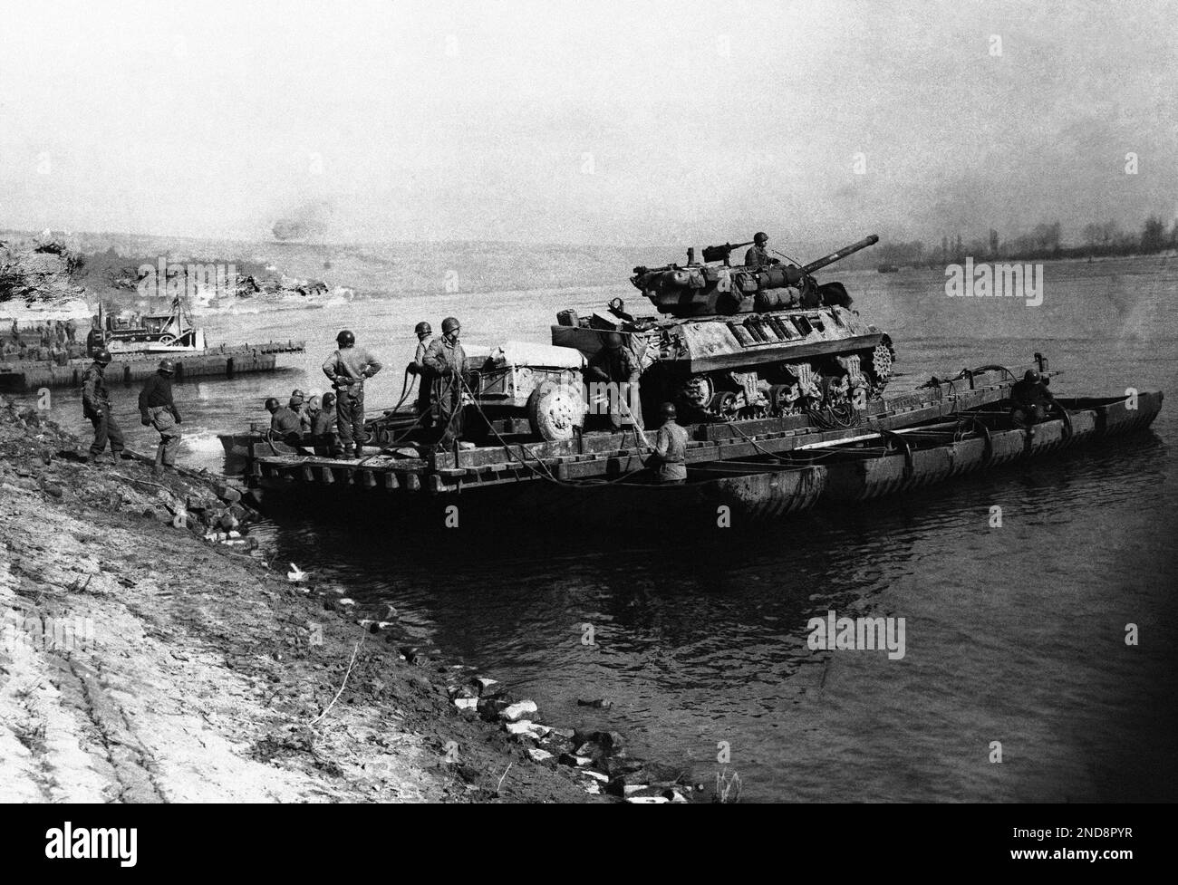 An American tank destroyer loaded onto a pontoon raft ready to be ...
