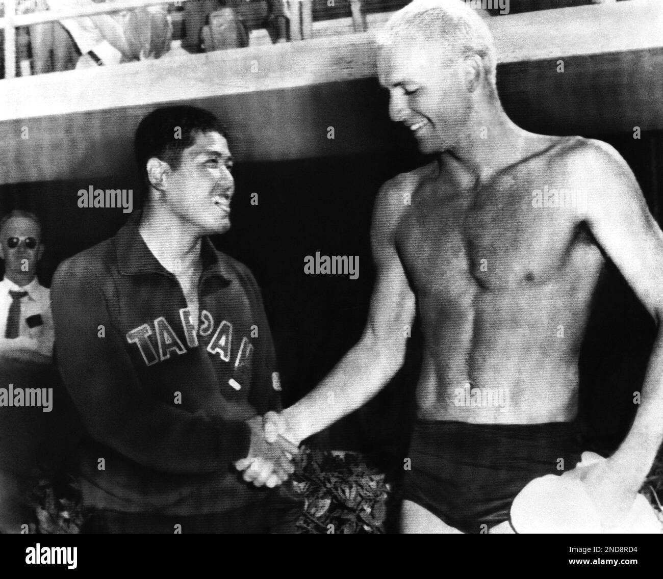 U.S. swimmer Lance Larson, right, is congratulated by Japanese swimmer Katsuki Ishihara, after ...