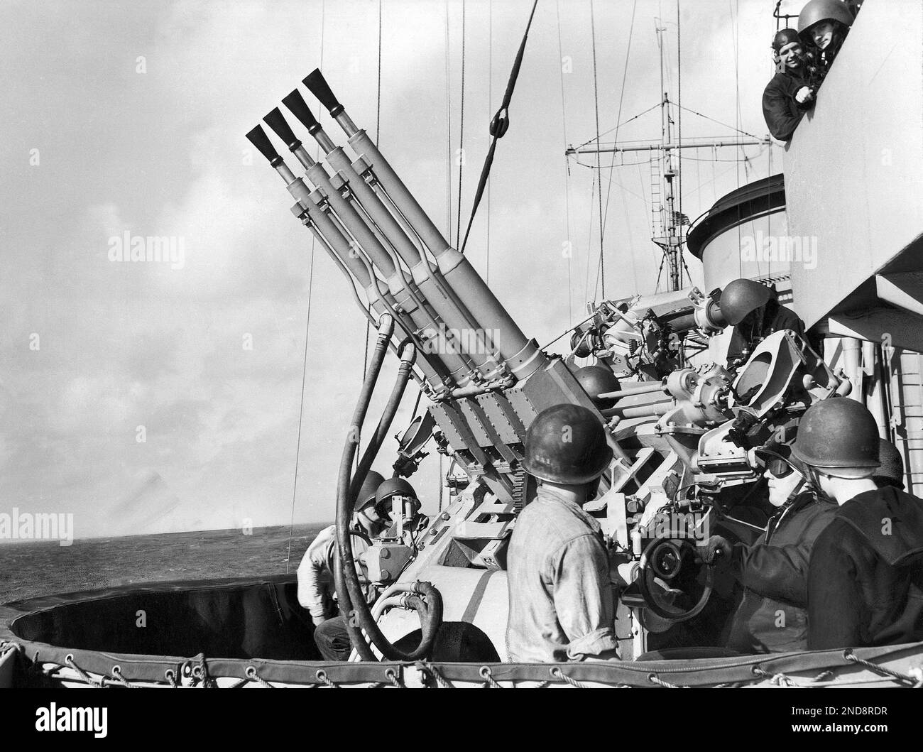 The crew of a battery of four 1.1-inch anti-aircraft guns stand to ...