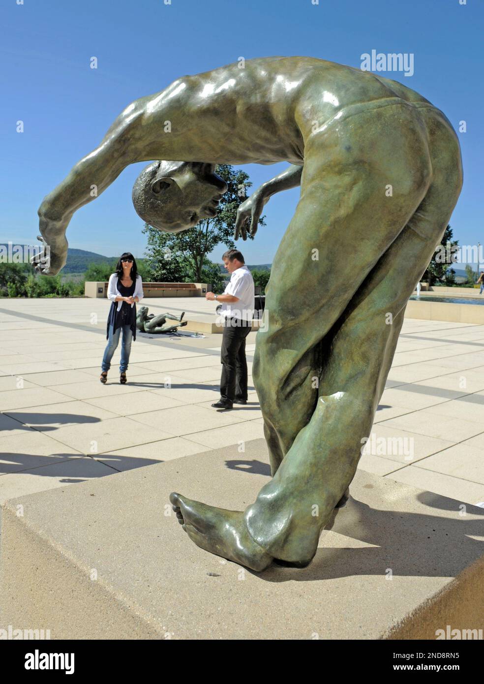 People stand behind the bronze sculpture 'Levity' of Dutch artist Lotta ...