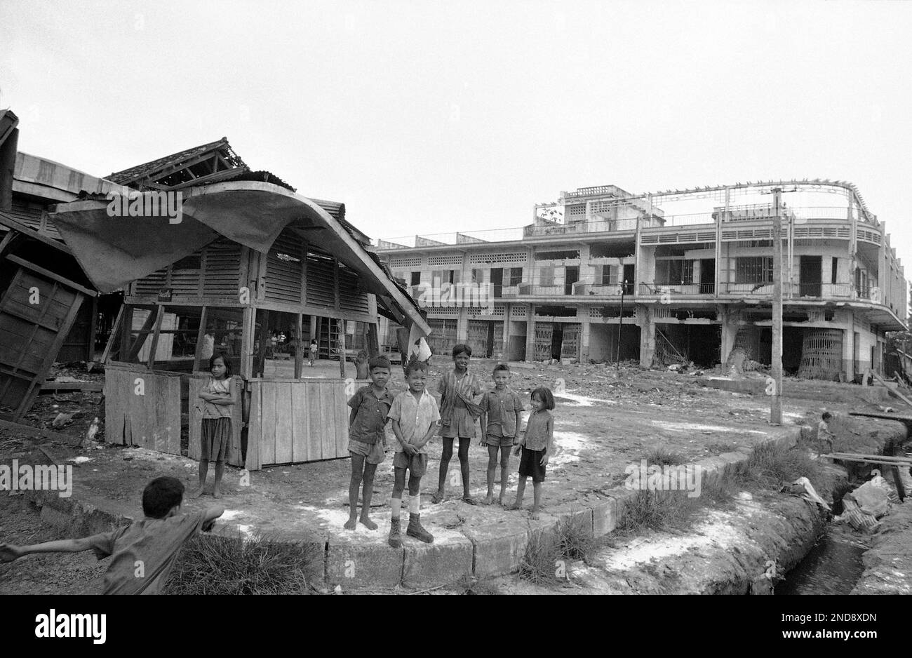 Cambodian children stand in battered marketplace of Neak Luong, a Mekong River town southeast of ...