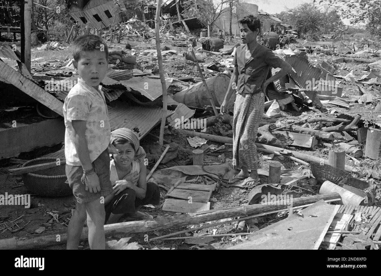 Members of a Cambodian family in the ruins of their home near Neak Luong August 7, 1973. It was ...