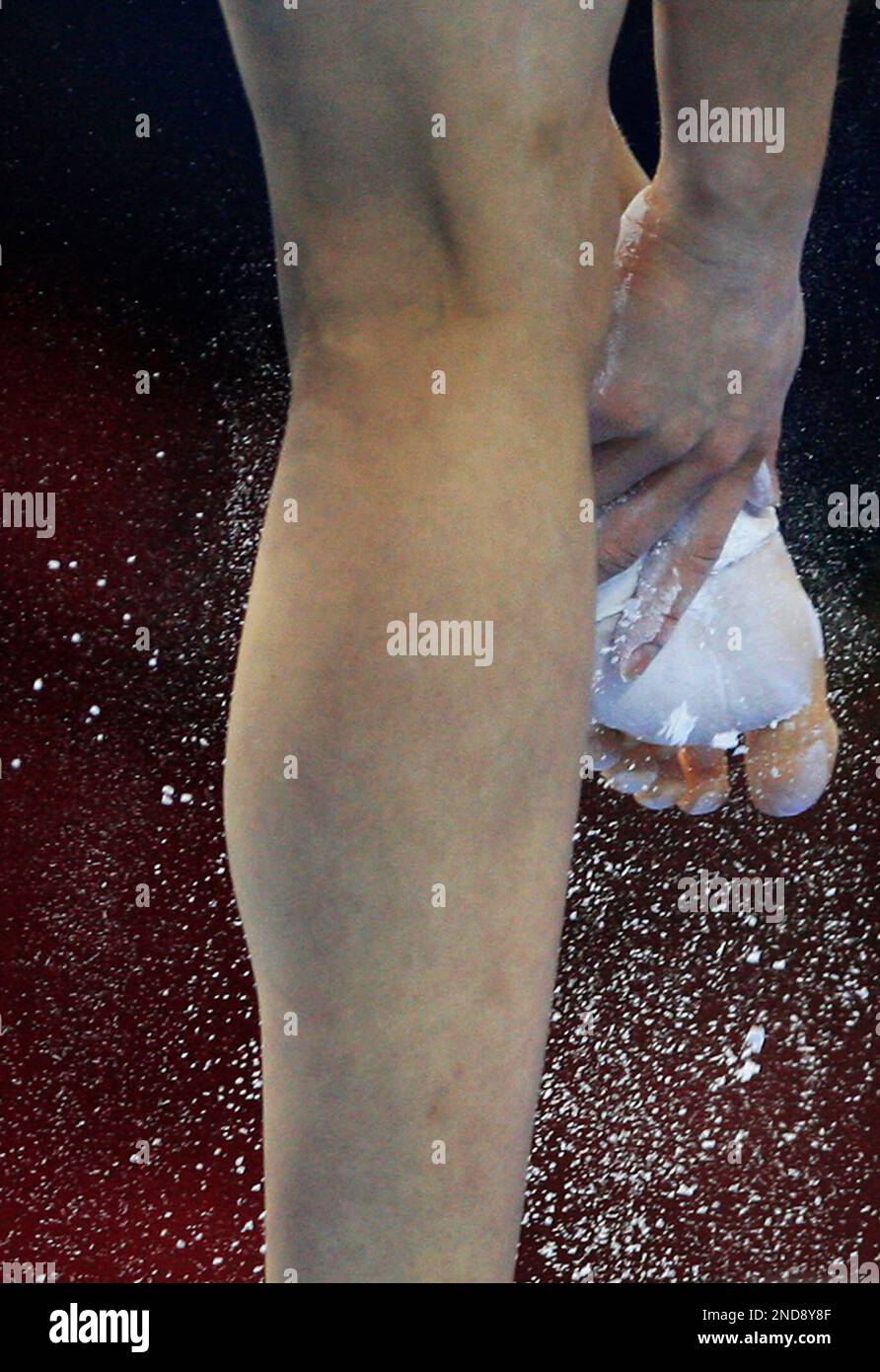 Angela Donald of Australia powders her foot before mounting the Beam ...