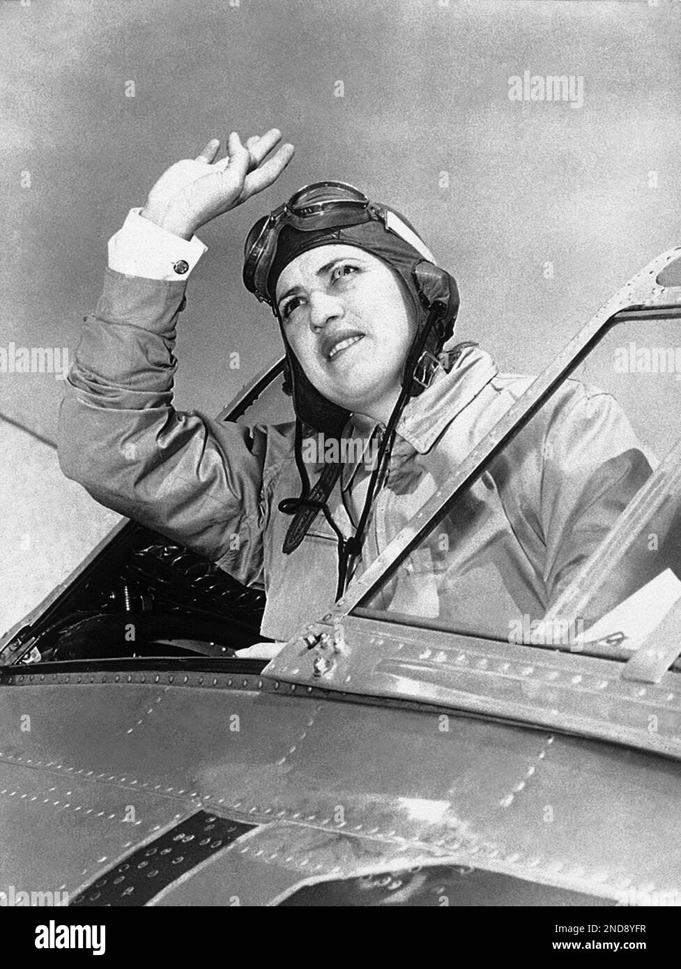 Miss Jacqueline Cochran, American aviatrix is waving from the cockpit ...