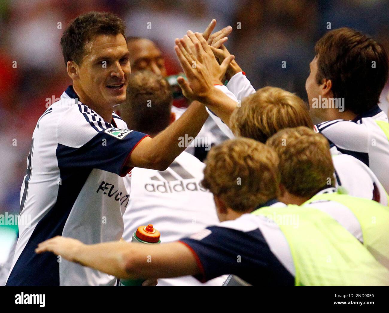 New England Revolution forward Marko Perovic, left, celebrates with ...