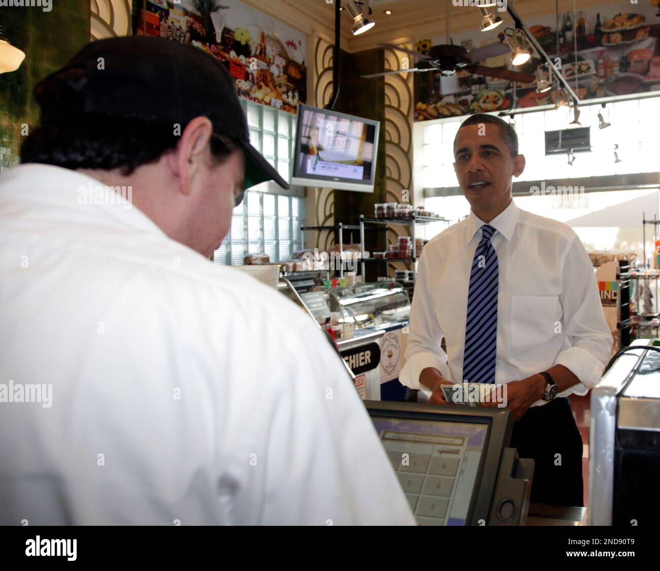President Barack Obama prepares to order food at Jerry's Famous Deli ...