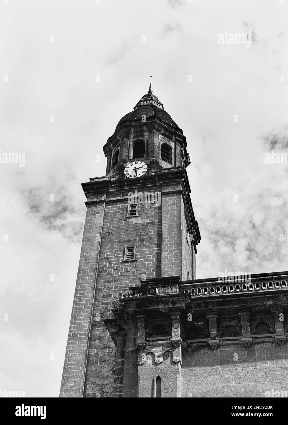 A vertical grayscale shot of a historic tower in the Old Town of Manila ...