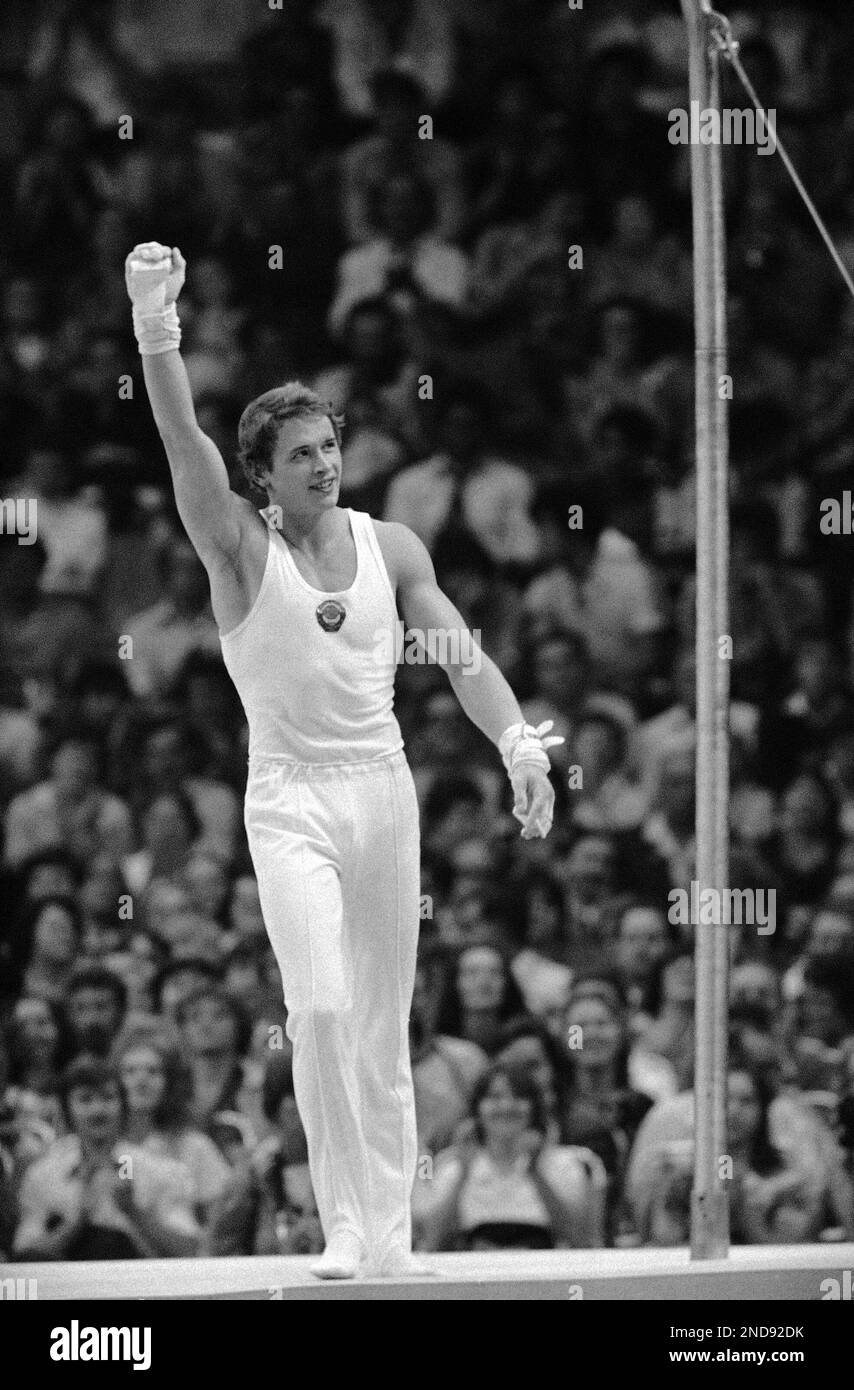 Soviet world champion Alexander Dityatin salutes fans in the stands ...