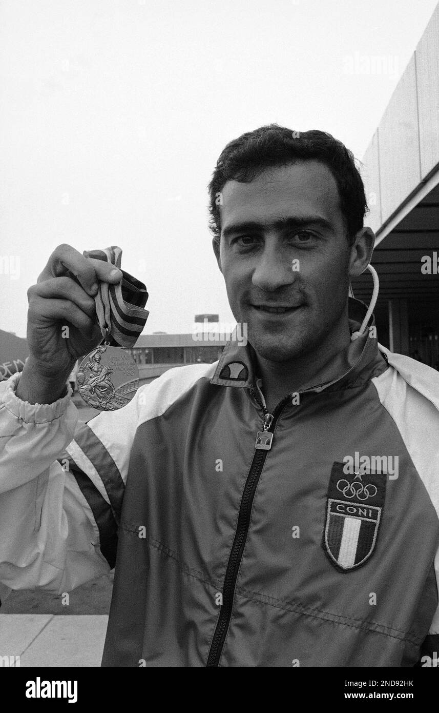 Italy’s Maurizio Damilano proudly shows off his gold medal he won at ...