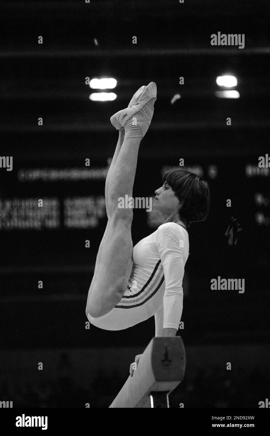 Romanian gymnast Nadia Comaneci balances as she lifts herself over ...