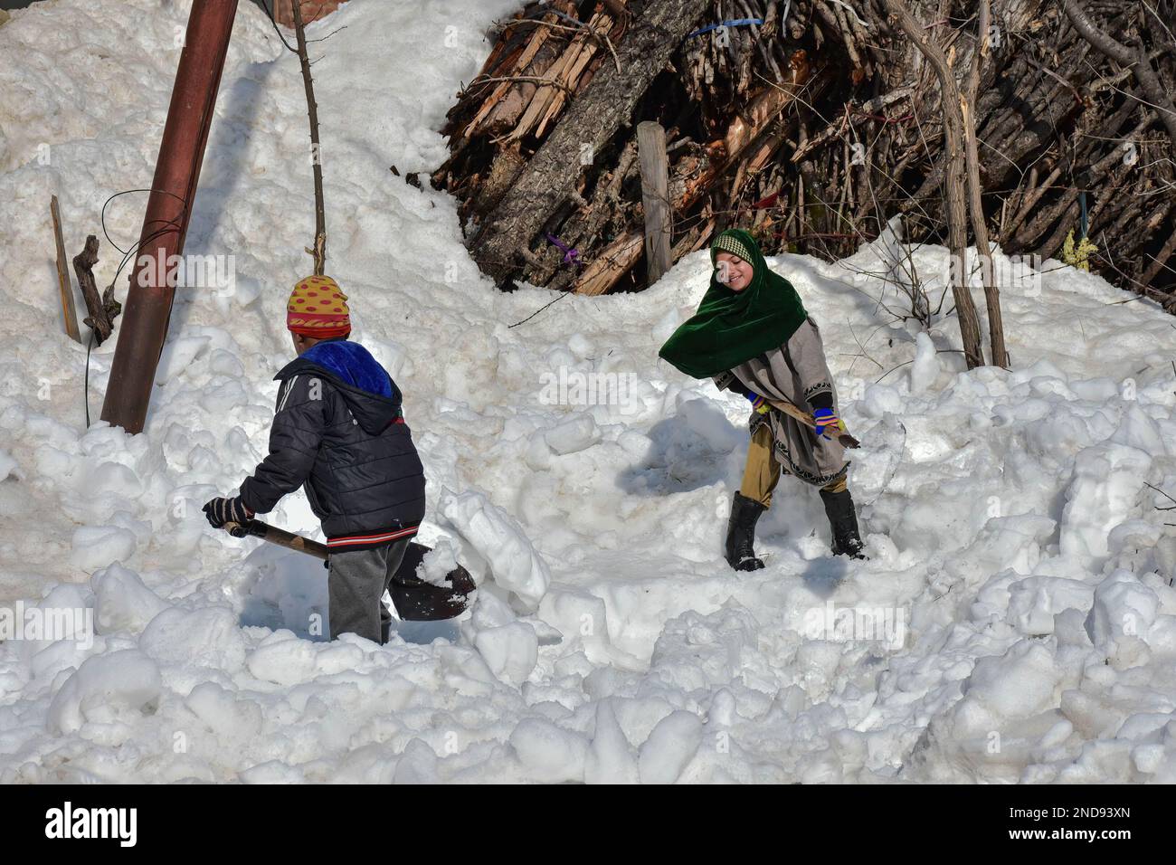 Tangmarg, India. 15th Feb, 2023. Kashmiri children clear snow around ...