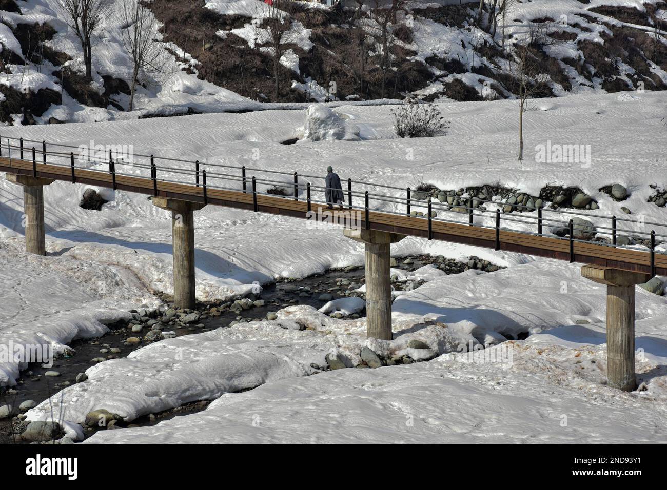 Tangmarg, India. 15th Feb, 2023. A Kashmiri man walks along the foot ...