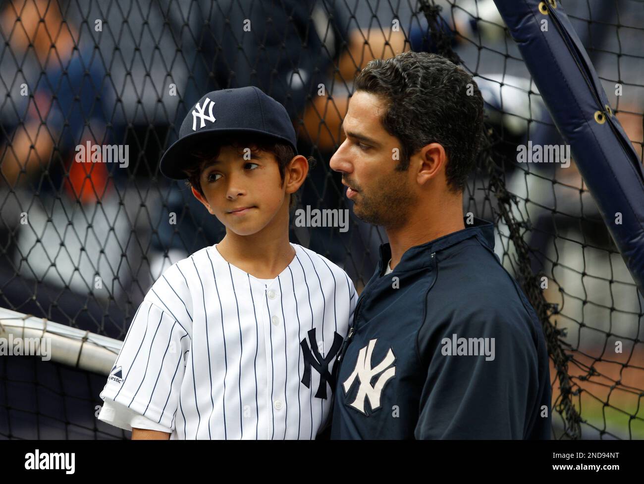 New York Yankees catcher Jorge Posada talks to his son Jorge Jr. beside ...
