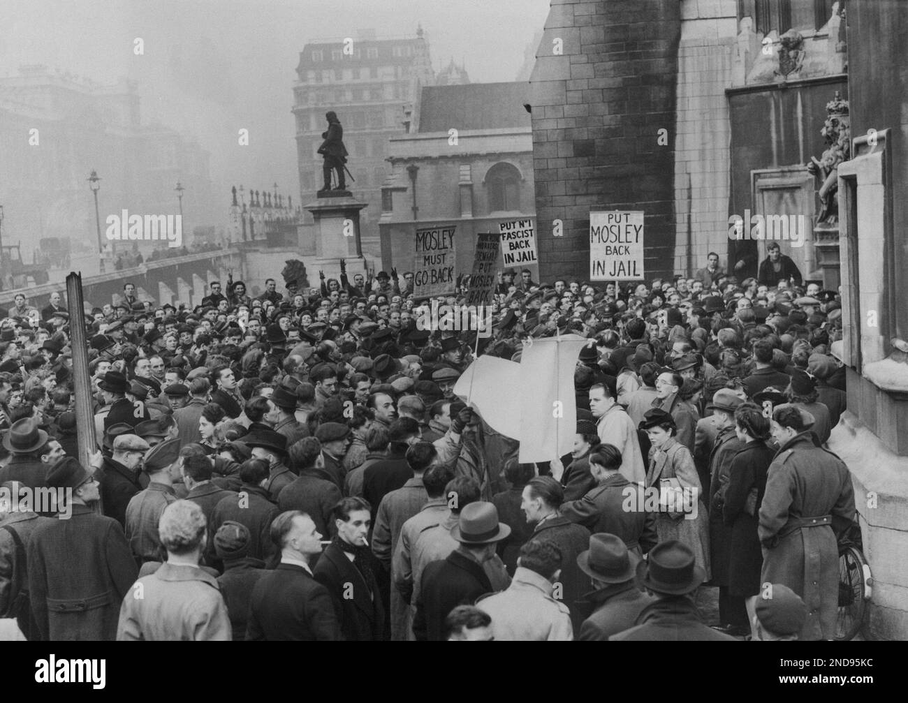 A crowd of workers, many carrying Anti-Mosley banners, demonstrates ...