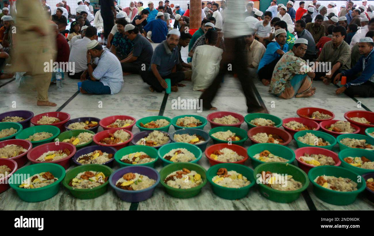 Bangladeshi Muslim devotees wait for Iftar, the meal that breaks the ...