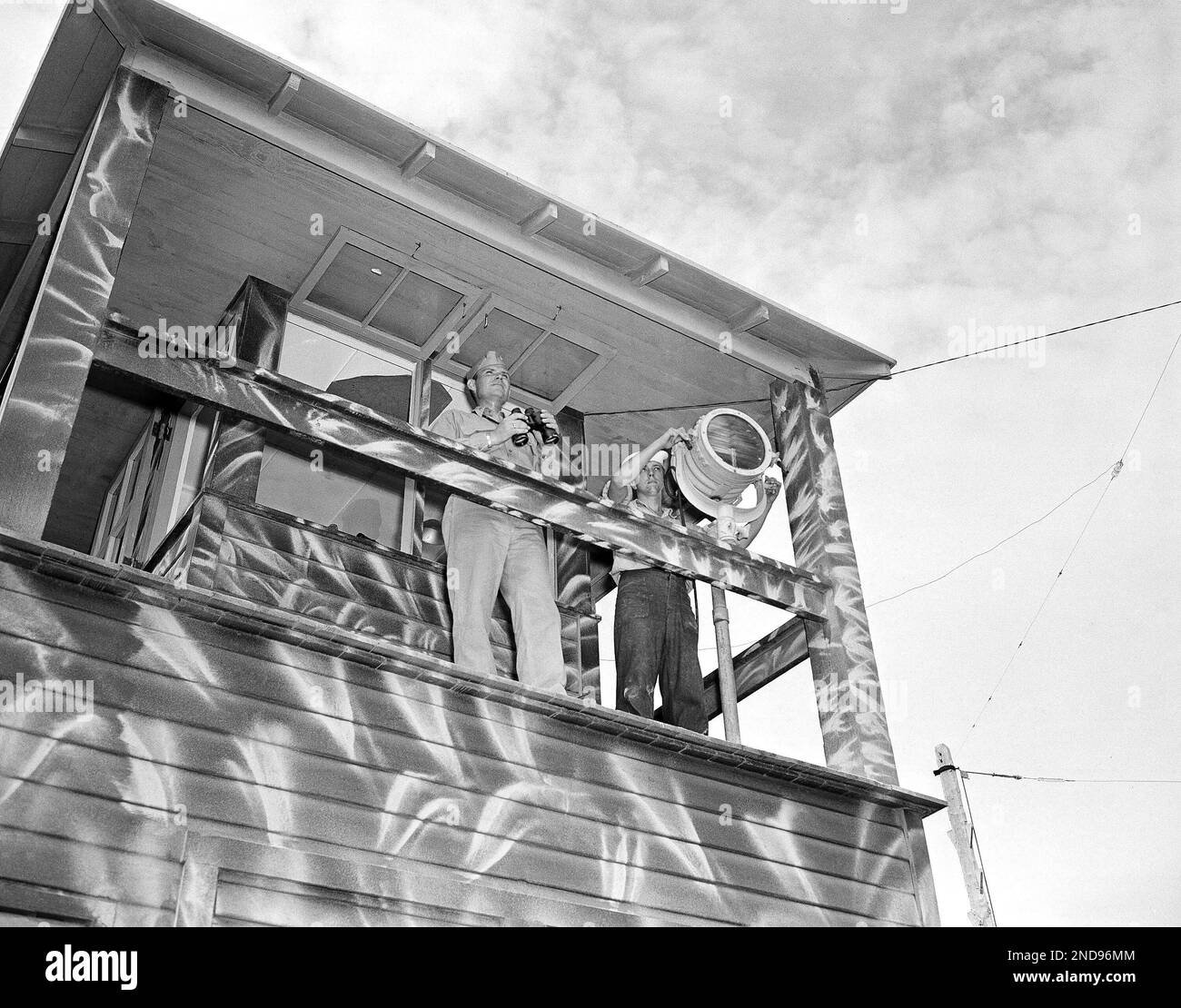 Signal tower and lookout station is manned by Ensign Leon Pledger of Lake Dallas, Texas and Fred ...