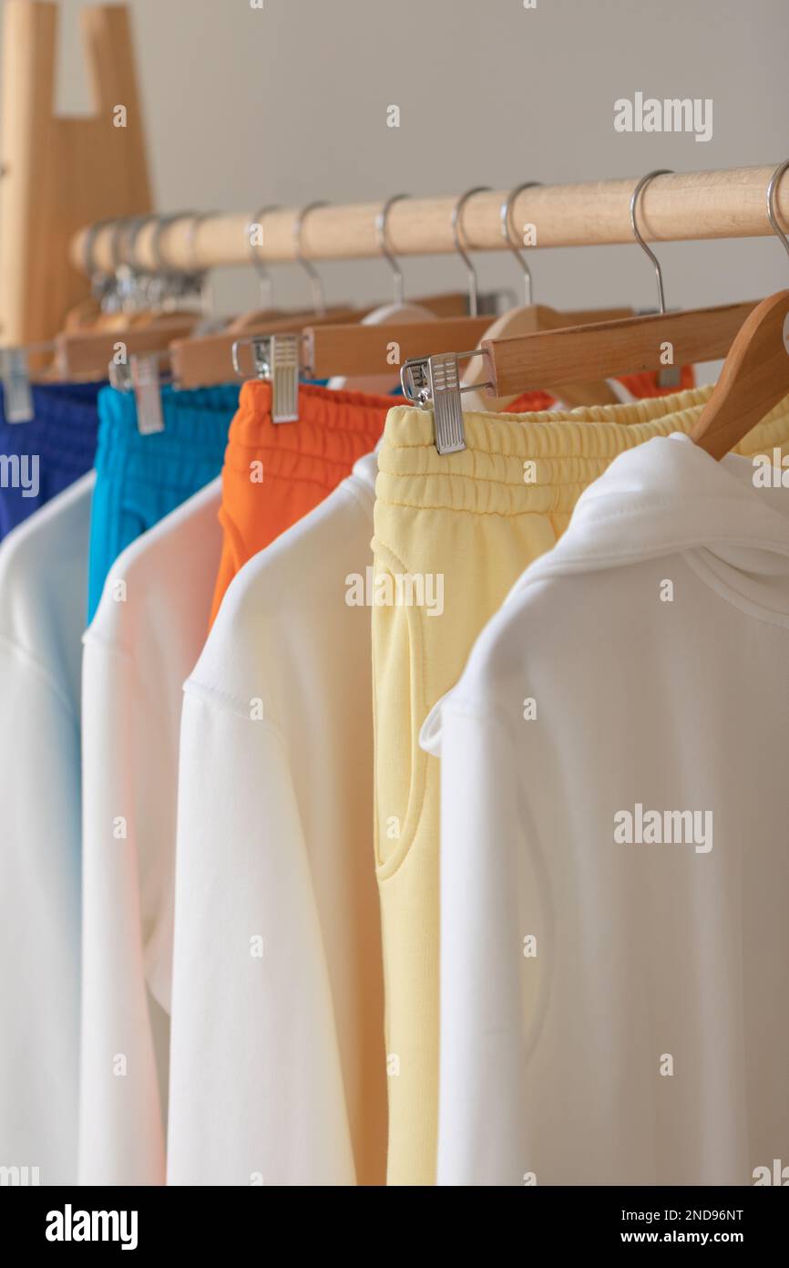 Clothes hang on a shelf in a designer clothes store. hangers with ...