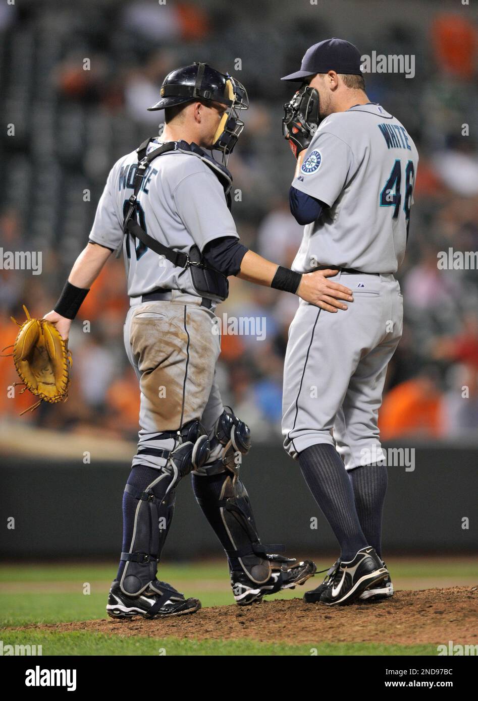 Seattle Mariners catcher Adam Moore talks with pitcher Sean White with ...