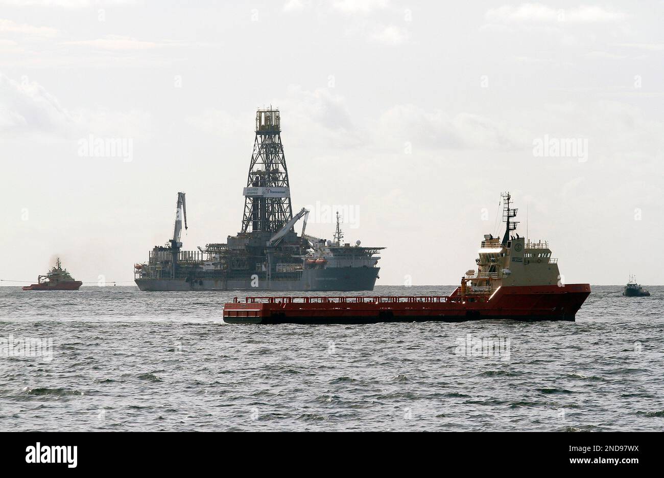 The Transocean Discoverer Enterprise is seen past a vessel, center left ...