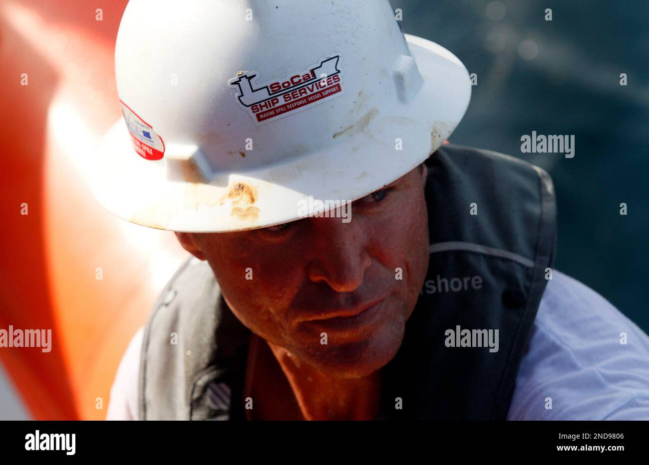Smudged oil is seen on the brim of a hard hat belonging to responder ...