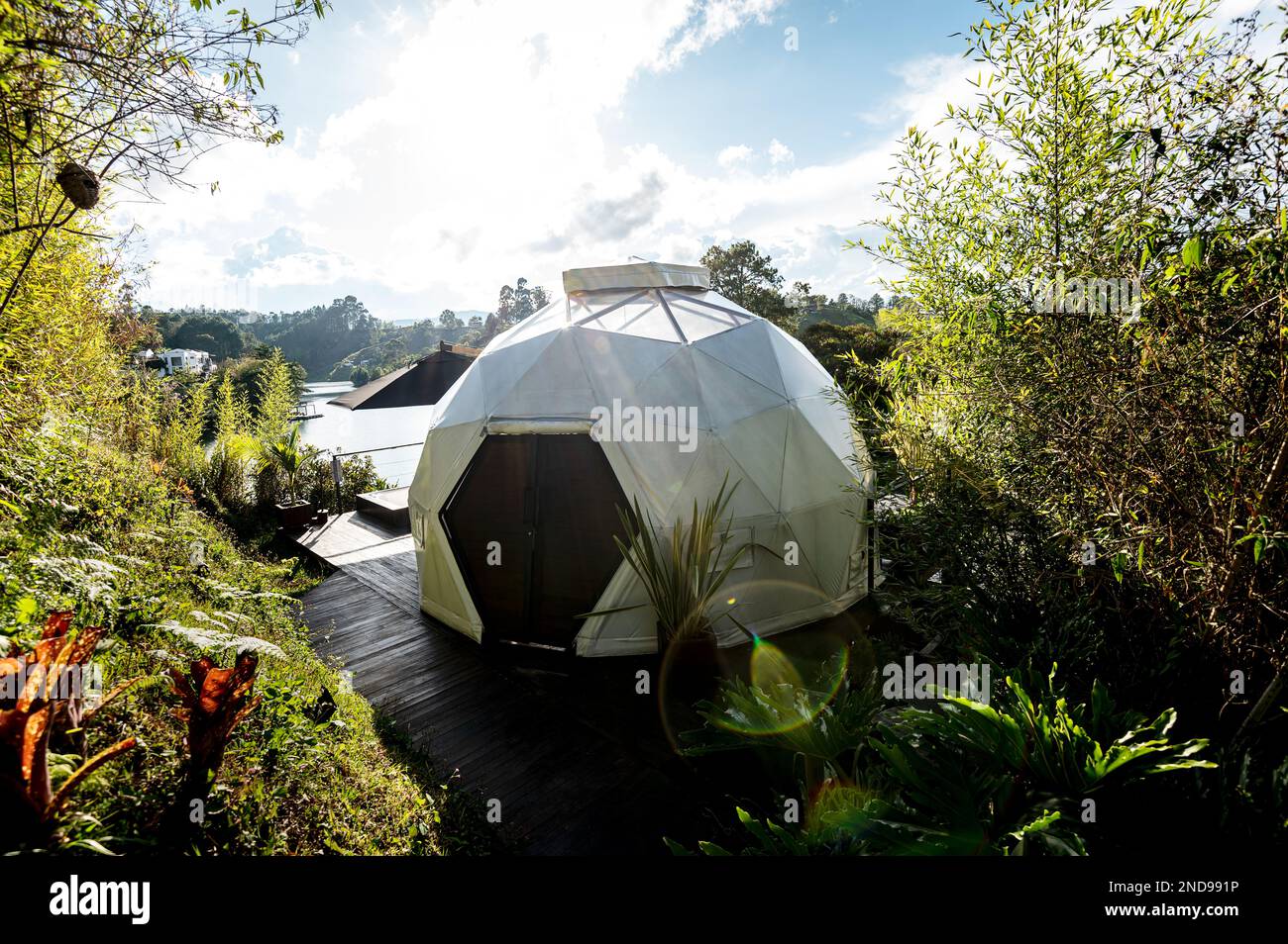 Glamping tent with wooden terrace by lake in Colombia Stock Photo - Alamy