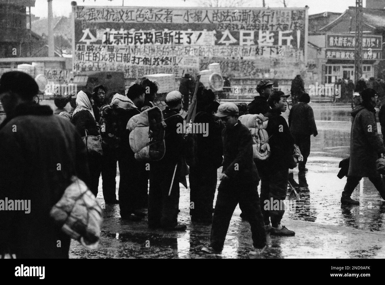 Red Guards with heavy luggage on their shoulders, gather during snow ...