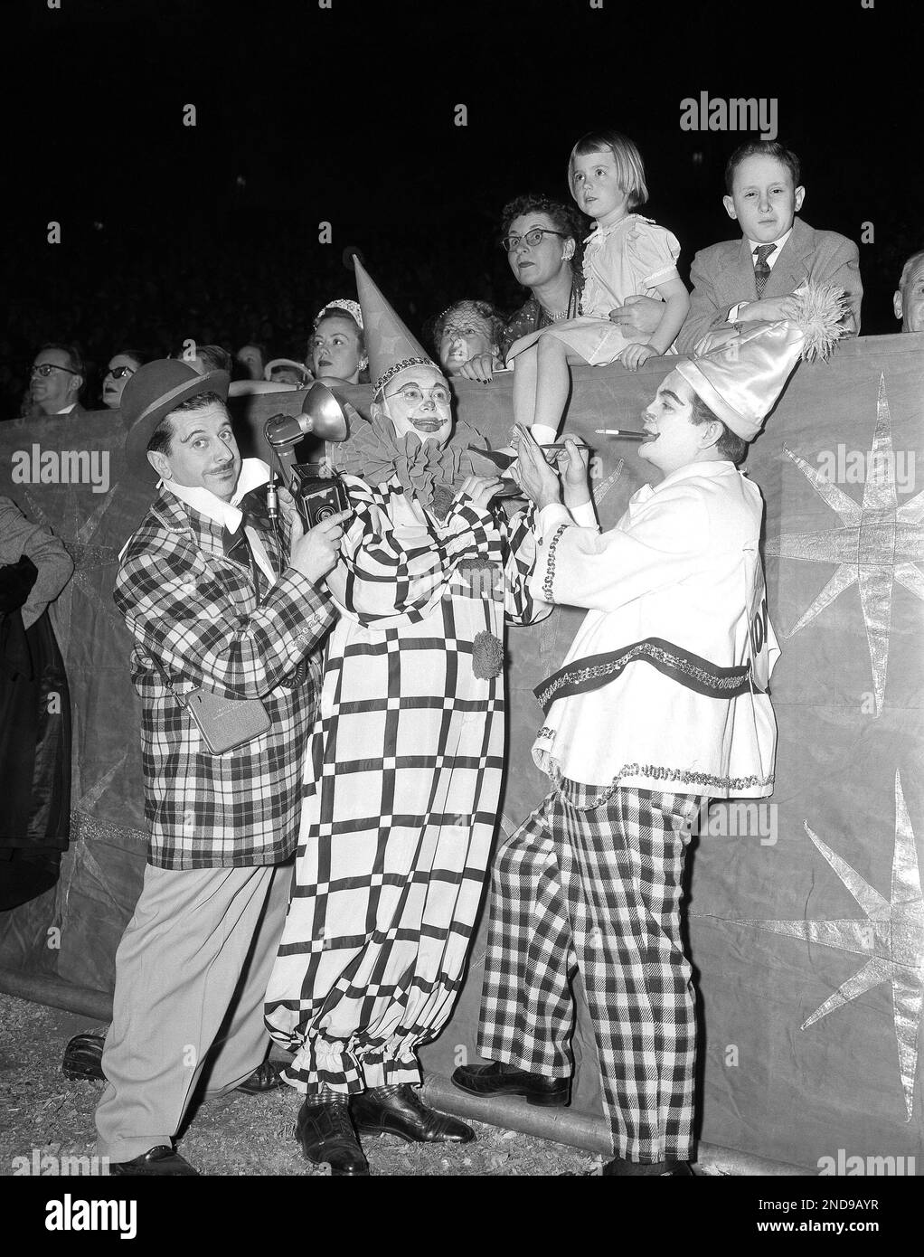 Stars of entertainment field dressed as clowns are, left to right ...