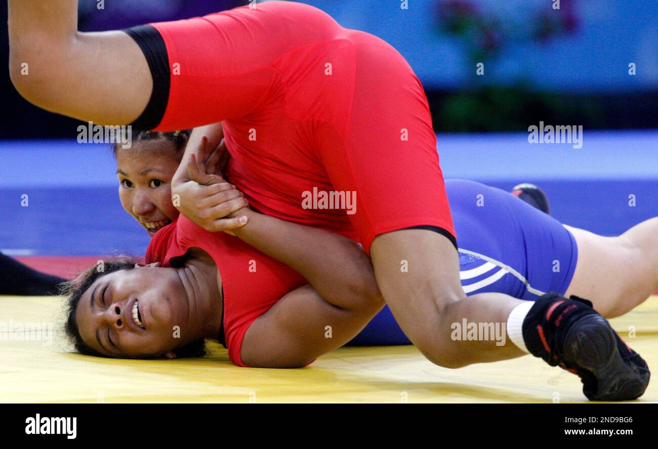 Rima Kushkenova of Kazahkstan, in blue, fights with Mohamed Thoraya of ...
