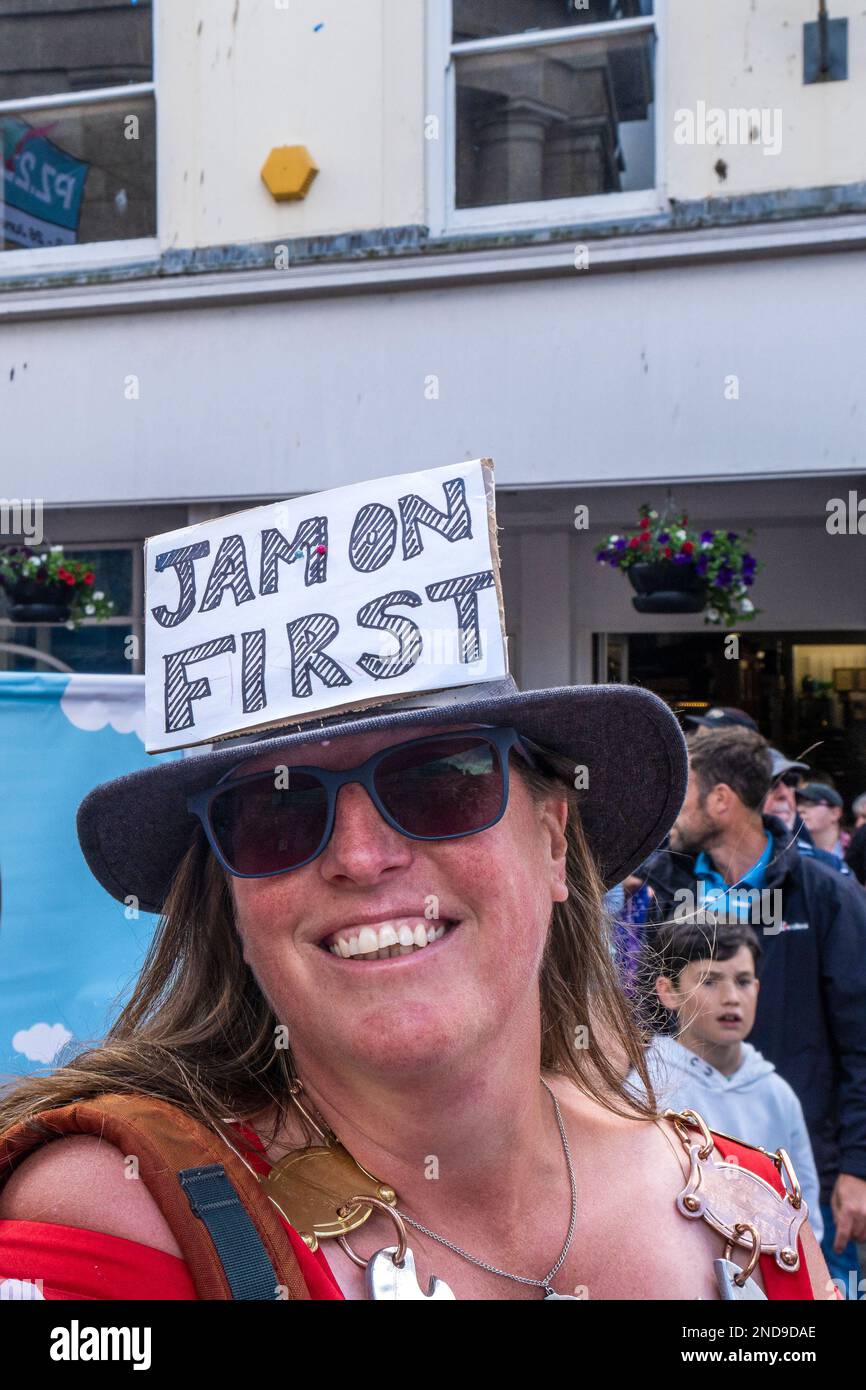 A Cornish woman wearing a hat with a sign stating Jam On First during ...