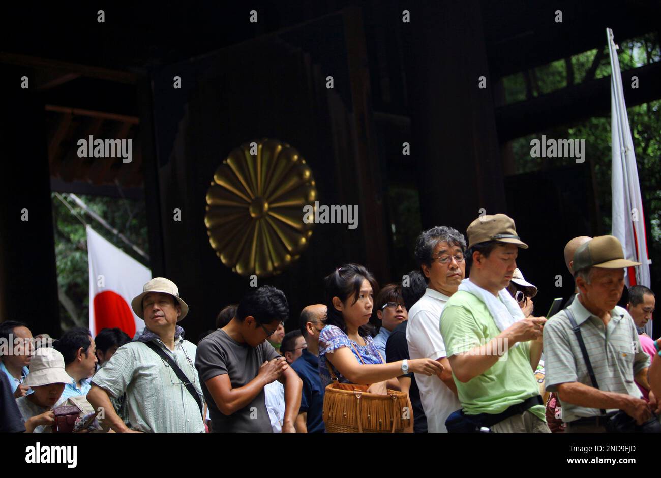 Visitors form a long queue to offer prayers at Yasukuni Shrine during a ...