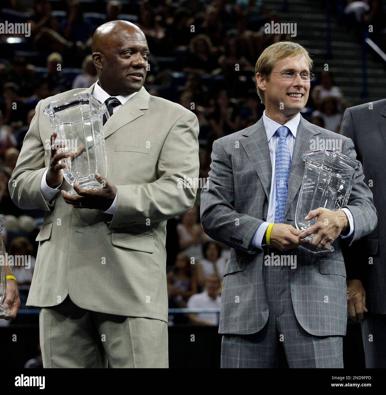 Ron Galimore, left, and Bart Connor stand as they and others from the ...
