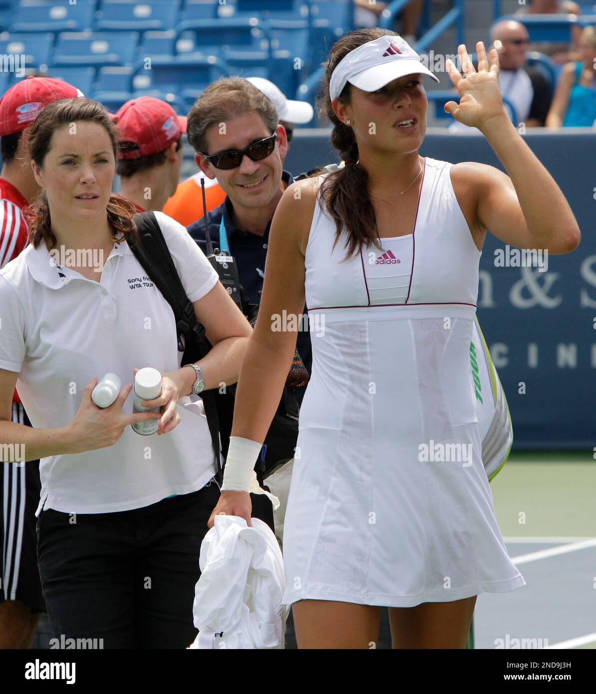 Ana Ivanovic, from Serbia, right, waves to the crowd as she leaves ...