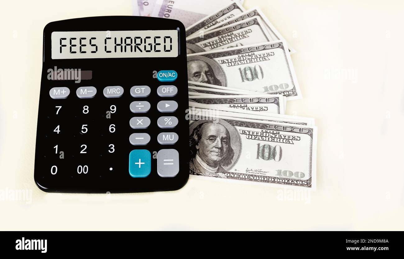 word TAKEN FEES on calculator and white background with dollars Stock ...