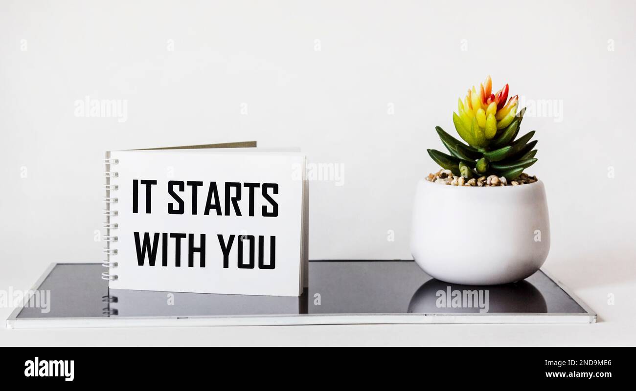 It starts with you, text on notepad and white and black background with ...