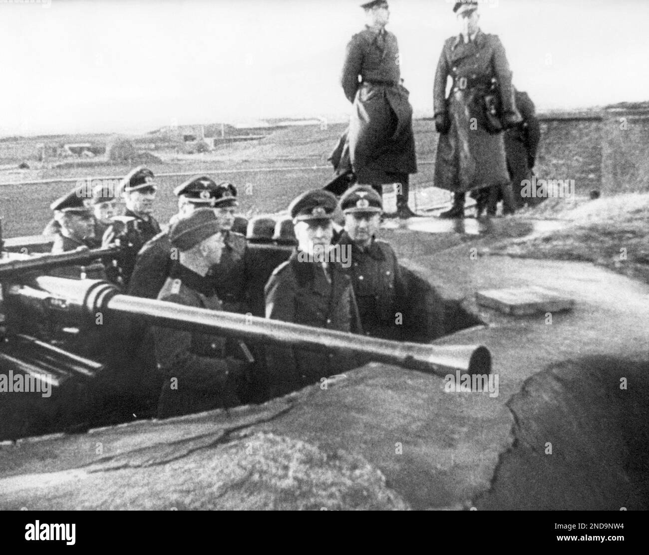 Marshal Erwin Rommel center-front, inspects a gun in a concrete ...