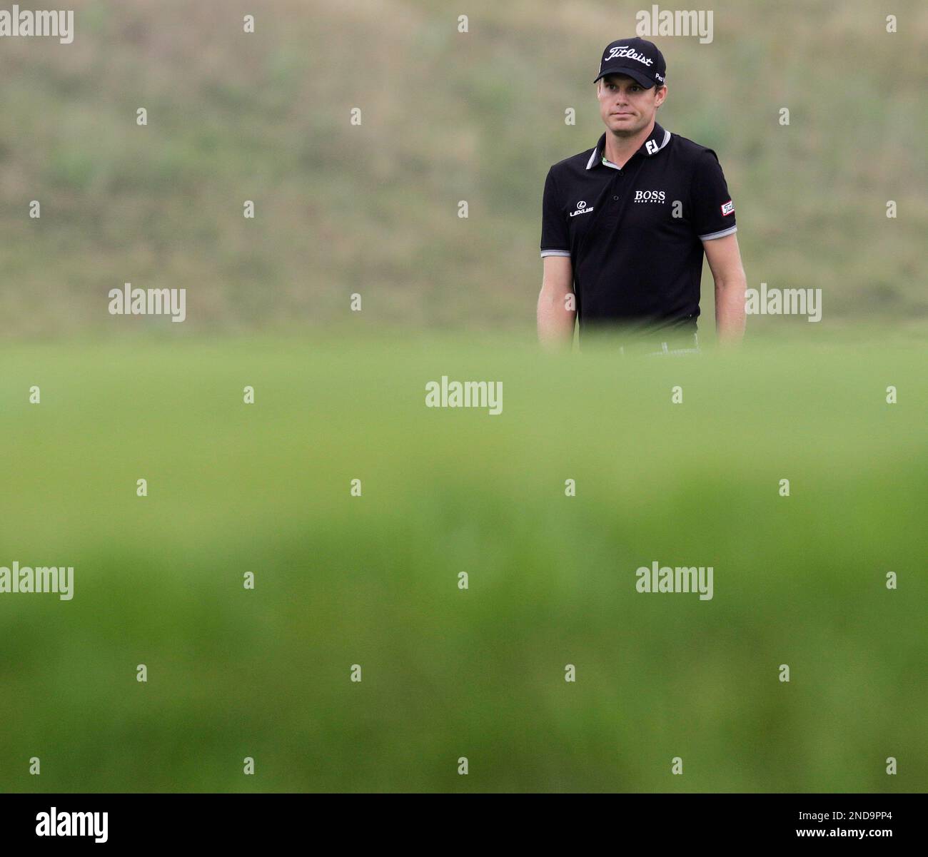Nick Watney watches his shot on the 14th hole during the first round of ...