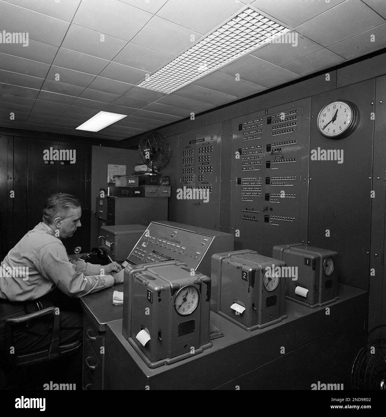 In front of panels of warning lights, Acting Lieut. Peter Denig, fire ...