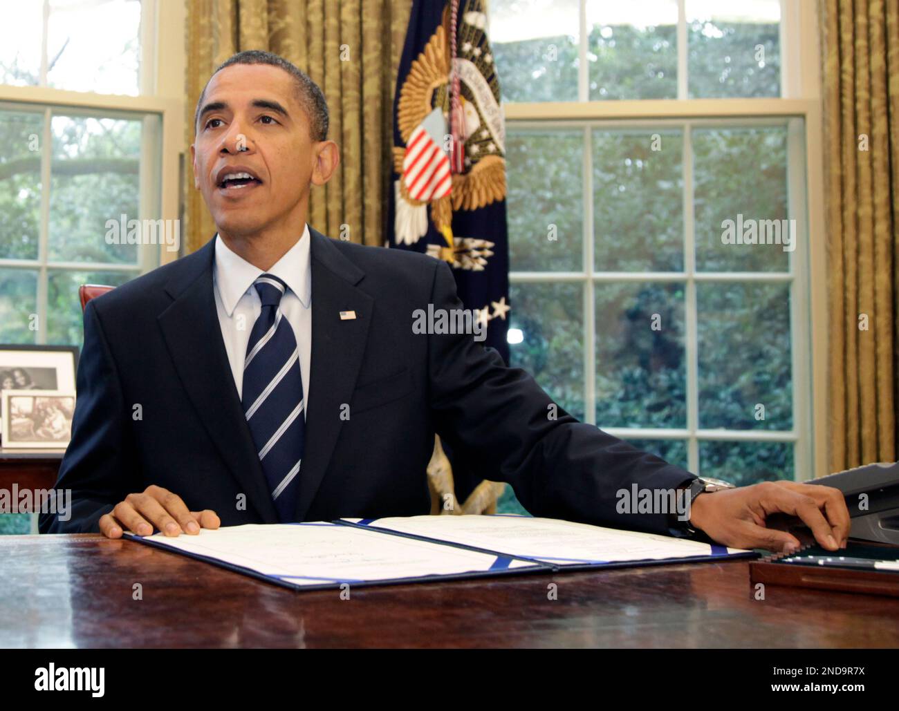 President Barack Obama looks up in the Oval Office of the White House ...